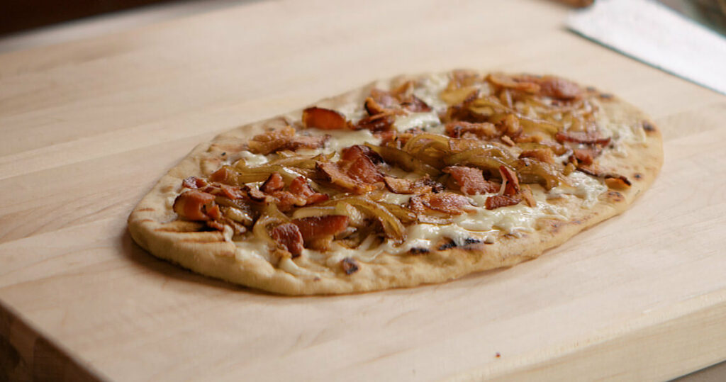 Caramelized Onion Flatbread with Bacon and Arugula | Our State